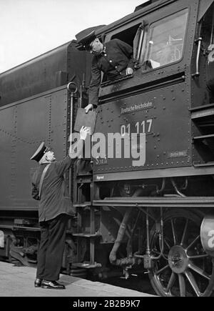 A railway train of the Deutsche Reichsbahn transport company on its way ...