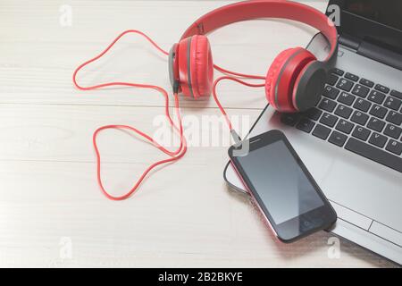 Laptop computer,glasses,earphone and smart phone on wood table Stock ...