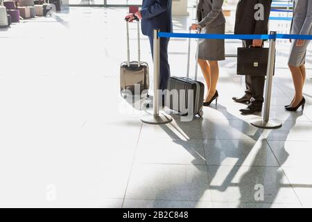 Business people queueing for check in airport Stock Photo - Alamy