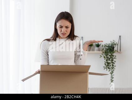 disappointed woman receive damaged wrong parcel Stock Photo - Alamy