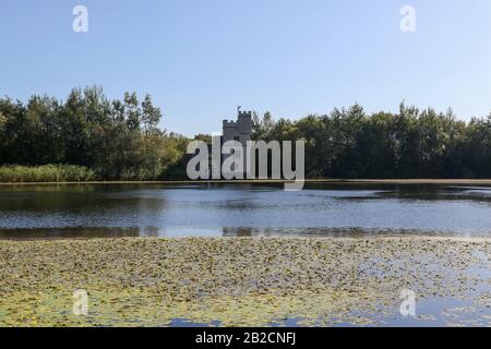 Modern castle folly in Ireland on Difflin Lake, Raphoe, Ireland, on a ...