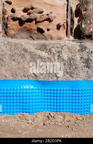 detail of cellar wall insulation at the construction site with worker ...