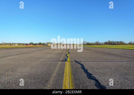 Cracking asphalt road, airport runway or airfield at Tempelhof Field ...