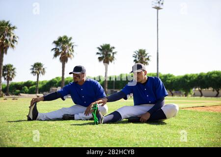Baseball players stretching Stock Photo - Alamy