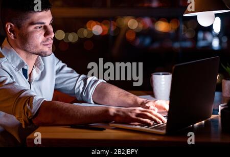 Young financial manager working late at night in office Stock Photo - Alamy