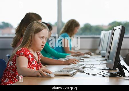 Teen with Down Syndrome using computer Stock Photo - Alamy