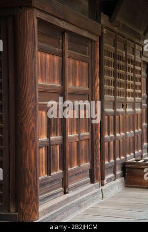 Japan, Kurashiki, Achi-jinja Shrine. Wooden frame with rows of omikuji ...