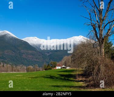 Mountains with green forests and agricultural land with farm ...