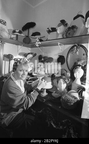 1980s, historical, millinery, a female milliner wearing one of her own ...
