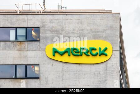 Yellow green Merck logo at the wall of a Merck office building. Merck ...