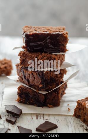 Chocolate cake on white plate over wooden table Stock Photo - Alamy