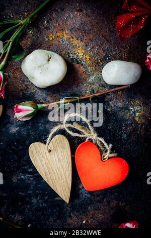 Two bounded hearts on rustic background Stock Photo - Alamy