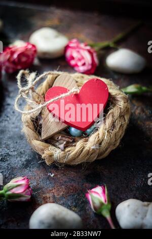 Two hearts bounded together on nest over black background Stock Photo ...
