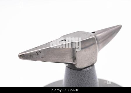 Closeup of a small anvil in front of white background Stock Photo - Alamy