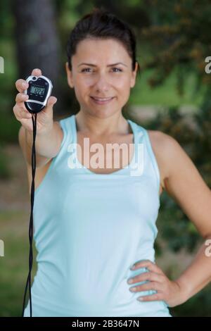 trainer showing the stop watch Stock Photo - Alamy