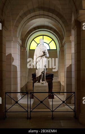 A statue of Voltaire and his tomb in the crypt of the Pantheon, Paris ...