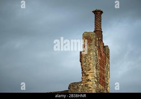 Tudor twisted barley sugar chimney pot on chimney stack with flint, red ...
