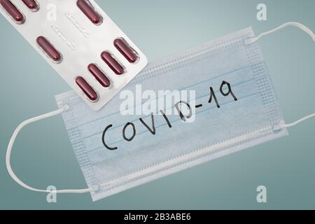 The inscription covid on a medical background, next to the vaccine ...