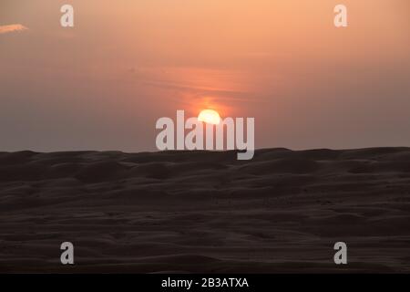 Sunset at the Wahiba desert camp, Oman Stock Photo - Alamy