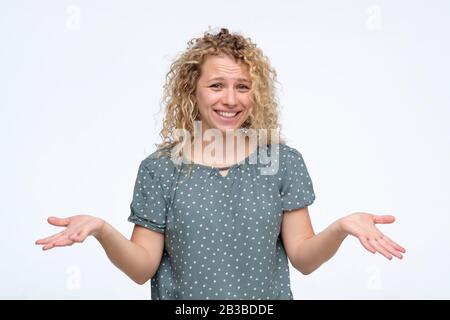 unsure woman with shrug and hands out gesturing uncertainty Stock Photo ...