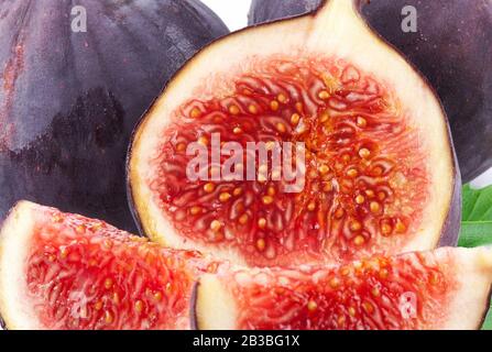 Fresh fig cut open showing the flesh and seeds inside on bed of ...