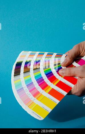 Multicolored color palette of a fixed set of colors in the hands of a ...