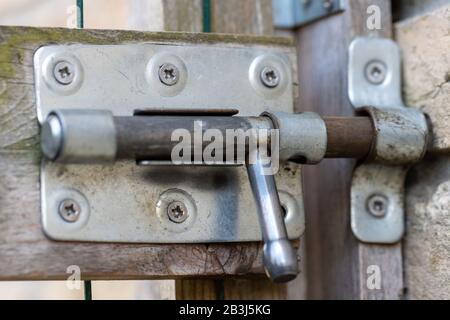 Steel sliding bolt lock on a security gate Stock Photo - Alamy