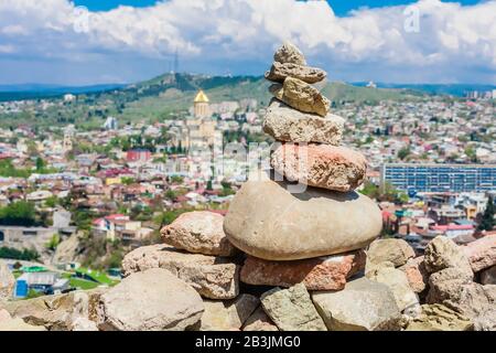 Pyramid of stones and panoramic view of Tbilisi city. Georgia Stock ...
