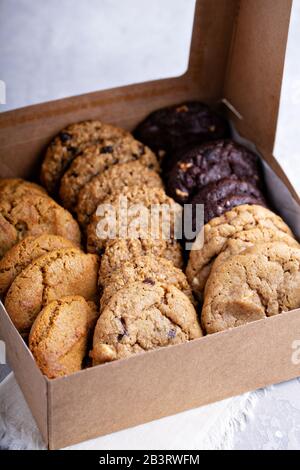 Delicious chocolate chip cookies are packed in a yellow cardboard box ...