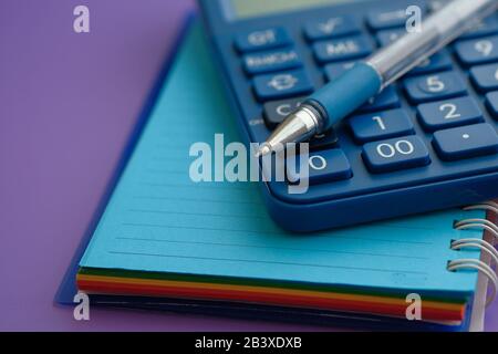 Close up of calculator, pen and notepad on desk Stock Photo - Alamy