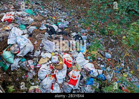 Illegal dump near the country sand road in the country. Sunny. Trash ...