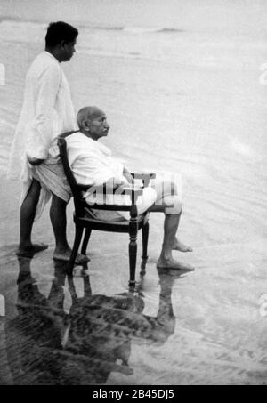 Mahatma Gandhi sitting on chair and Devdas Gandhi on Juhu Beach, Bombay ...