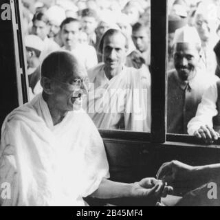 Mohandas Karamchand Gandhi collecting funds for Harijans at a railway ...