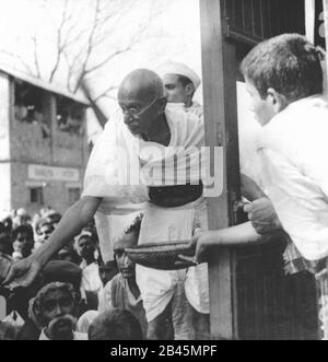 Mohandas Karamchand Gandhi collecting funds for Harijans at a railway ...