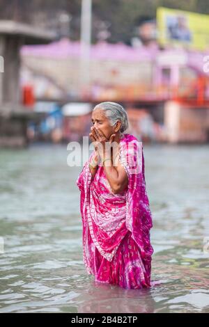 Hindu pilgrimage ritualistic bathing at the Ganges river at Haridwar ...