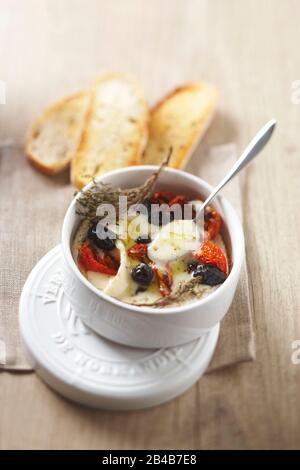 Melted cheese, baked goat cheese, olive tomato Stock Photo - Alamy