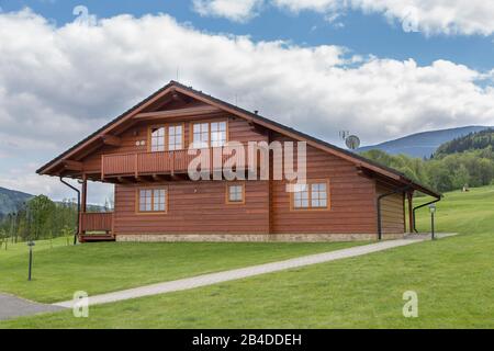 nice wooden house with lawn around Stock Photo - Alamy