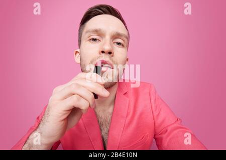 Man applying red lipstick Stock Photo - Alamy