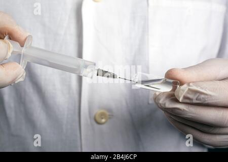 Nurse takes an ampoule of medicine from the manipulation table Stock ...