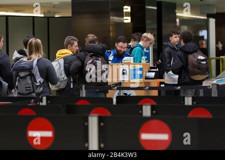 A TSA agent screens a passenger at a security checkpoint in the Central ...