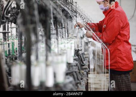 A Chinese worker labors at a textile factory in Yanshanhe Village ...