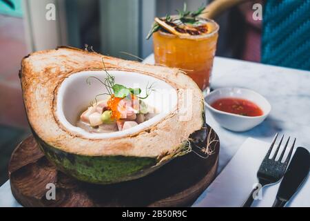 Hamachi and Coconut Ceviche Hamachi aguachile on a fresh, green coconut ...