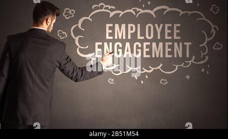businessman drawing a cloud with EMPLOYEE ENGAGEMENT inscription inside ...