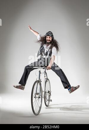 Portrait of a skinny geek riding a bike Stock Photo - Alamy