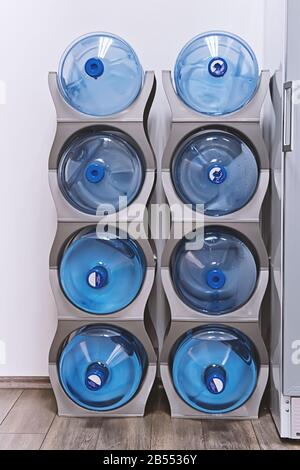 Electric water cooler on blue background Stock Photo - Alamy