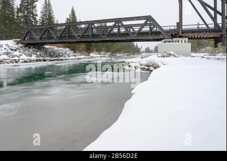 Snowy day at Engine Bridge pedestrian crossing over the Bow River in ...