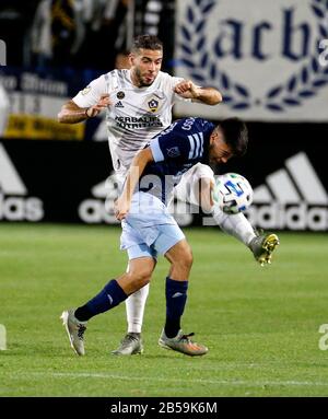 Vancouver Whitecaps midfielder Ryan Raposo, right, kicks the ball past ...