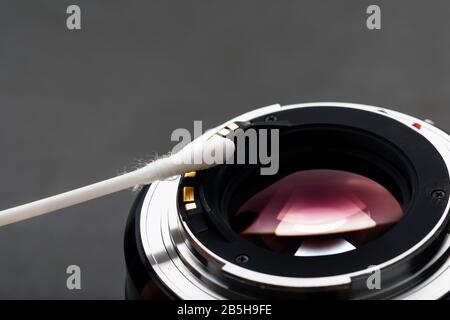 Gentle cleaning with a cotton swab camera Lens with a beautiful optical ...