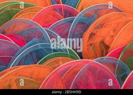 Close up of colorful fishing nets piled along waterfront. Commercial ...