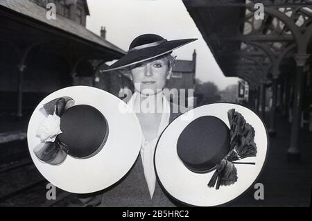 1980s, historical, millinery, a female milliner wearing one of her own ...